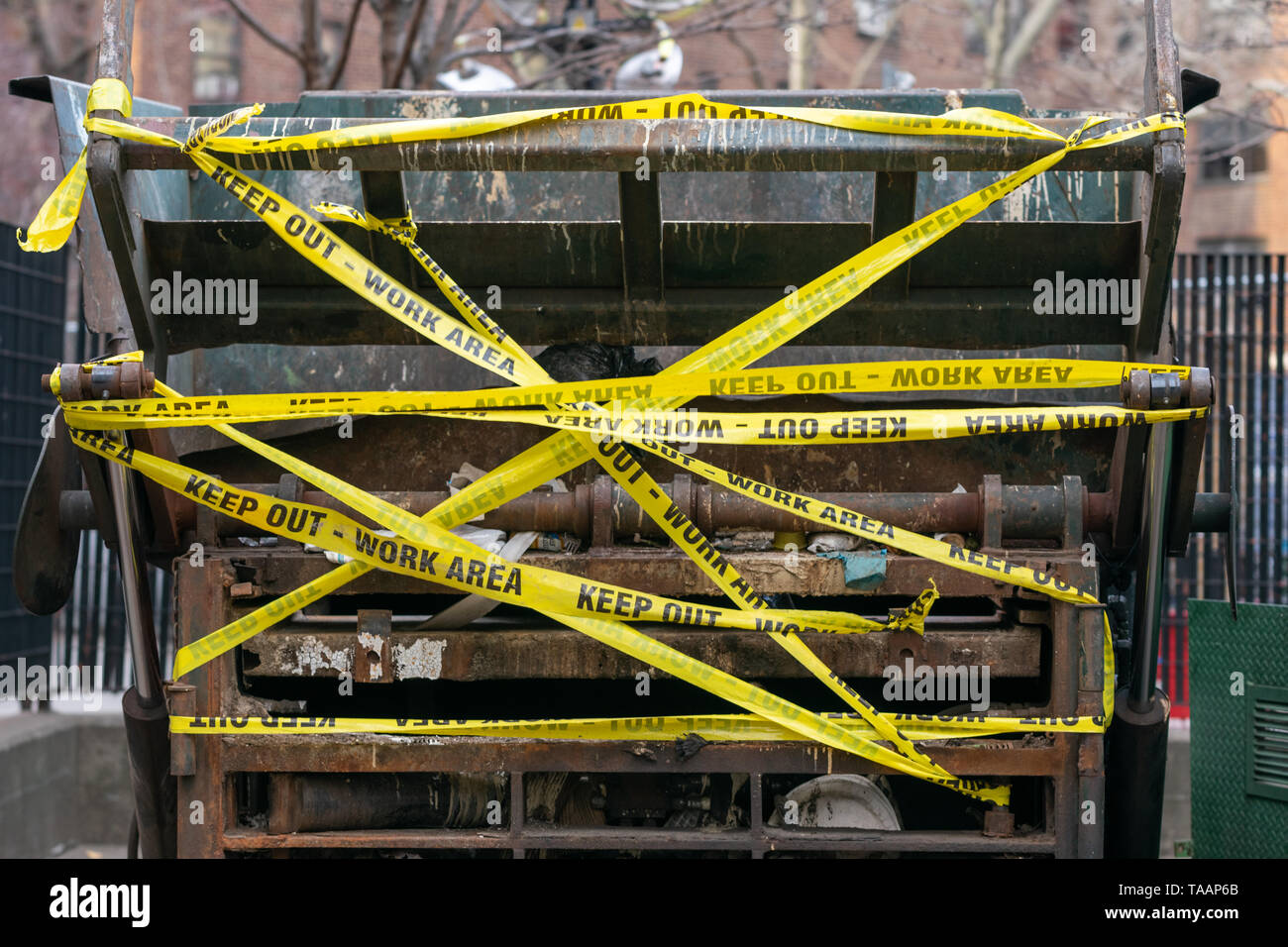 Keep out - Work area tape is wildly draped across an old rusty dirty ...