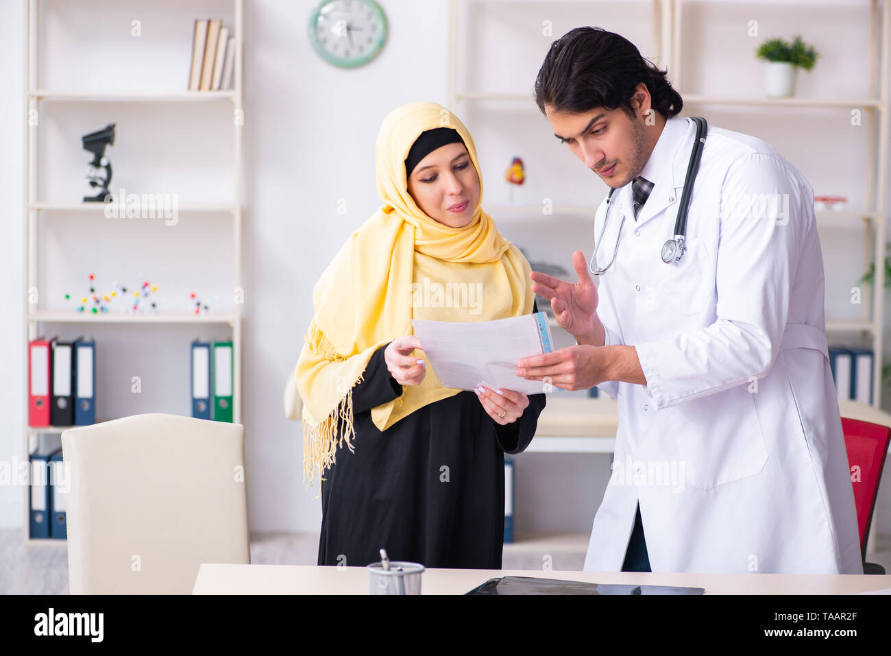 Female arab patient visiting male doctor Stock Photo - Alamy