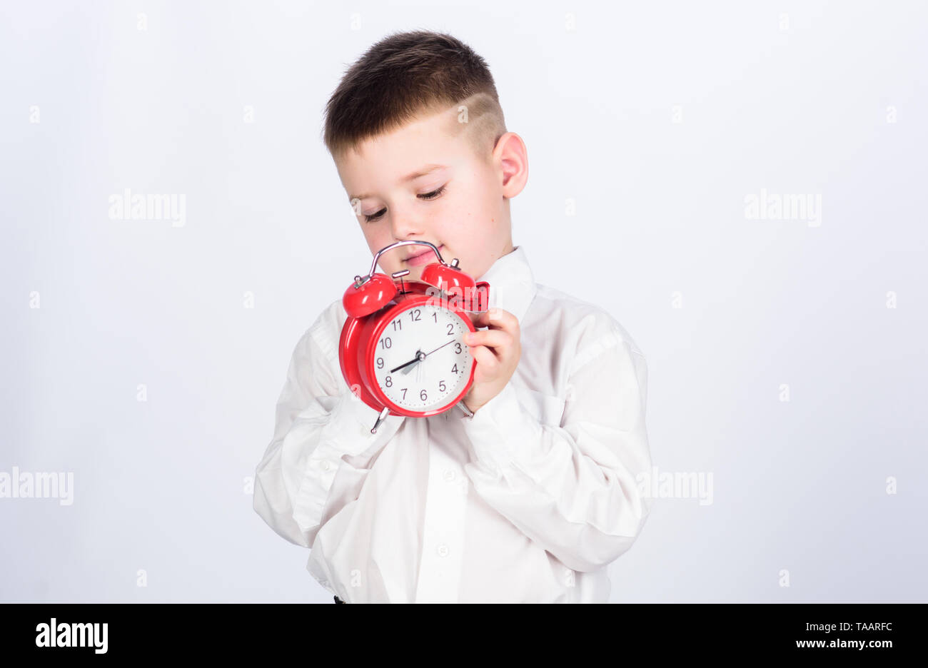 Schoolboy with alarm clock. Kid adorable boy white shirt red bow tie ...