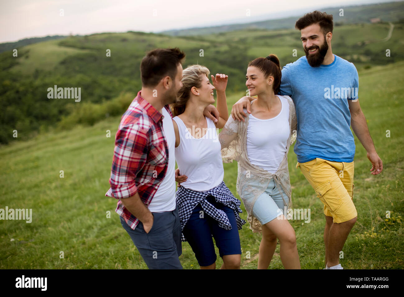 Group of happy young people walking in the summer field Stock Photo - Alamy