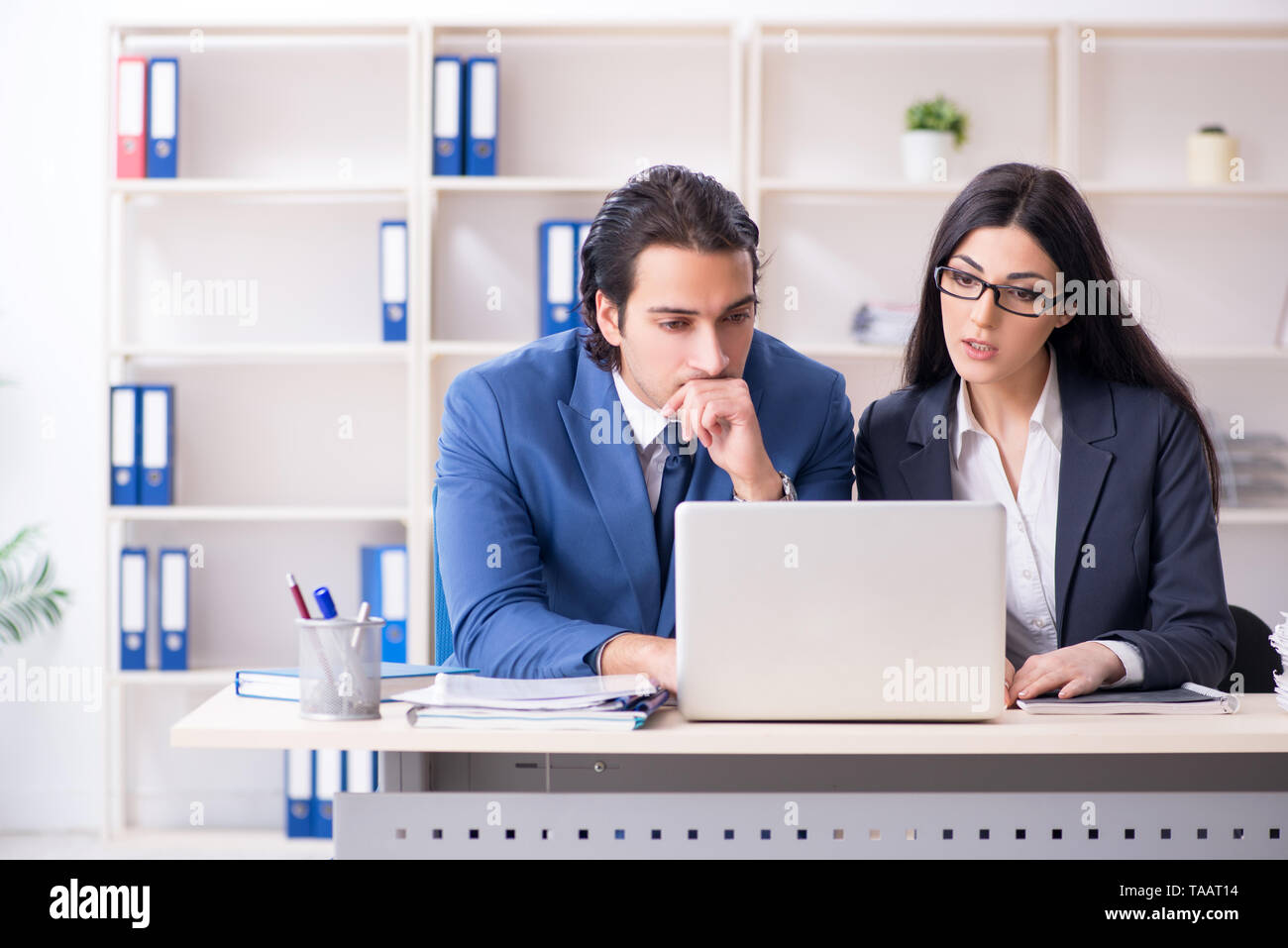 Two employees working in the office Stock Photo - Alamy