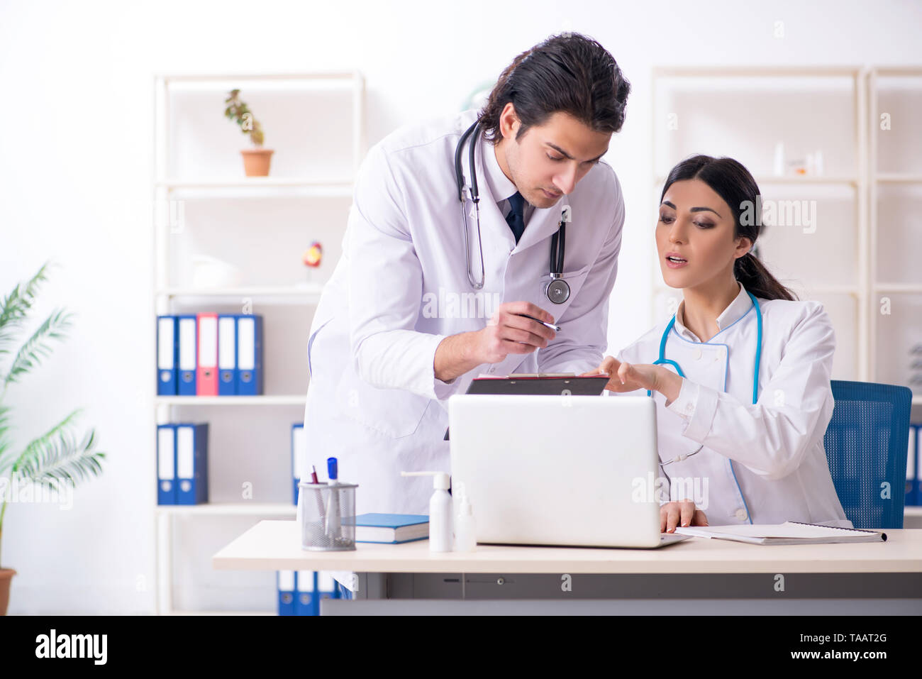 Two young doctors working in the clinic Stock Photo - Alamy