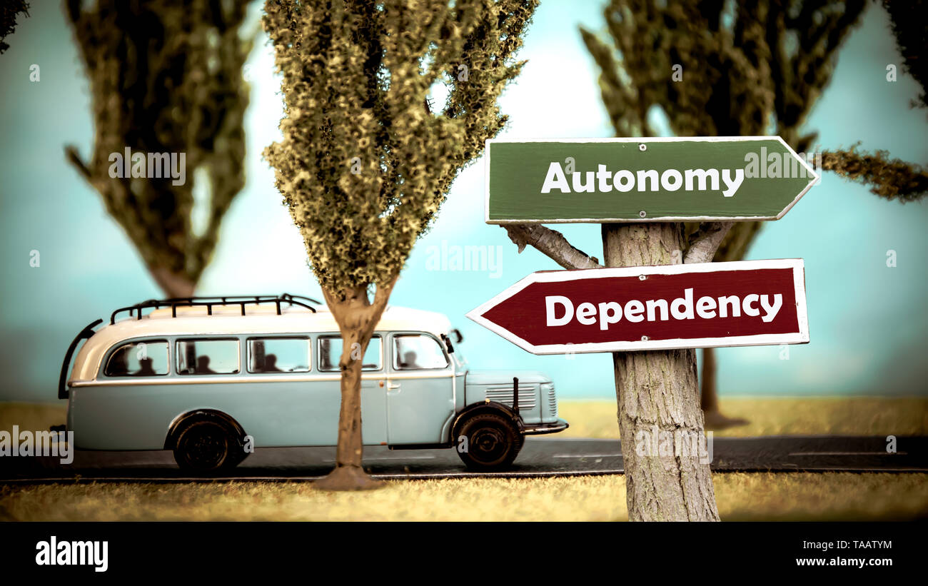 Street Sign the Direction Way to Autonomy versus Dependency Stock Photo ...