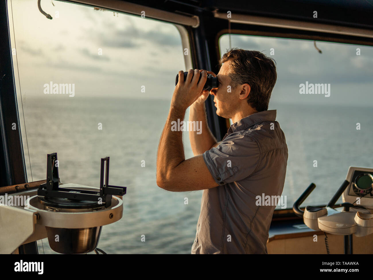 Navigational officer lookout on navigation watch with binoculars Stock ...