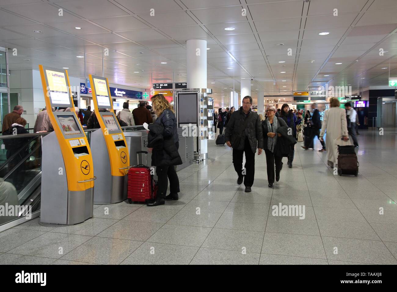 MUNICH, GERMANY - APRIL 1, 2014: People use self check in machines at ...