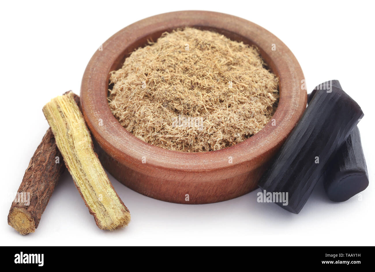 Liquorice powder in a bowl and candy over white background Stock Photo ...