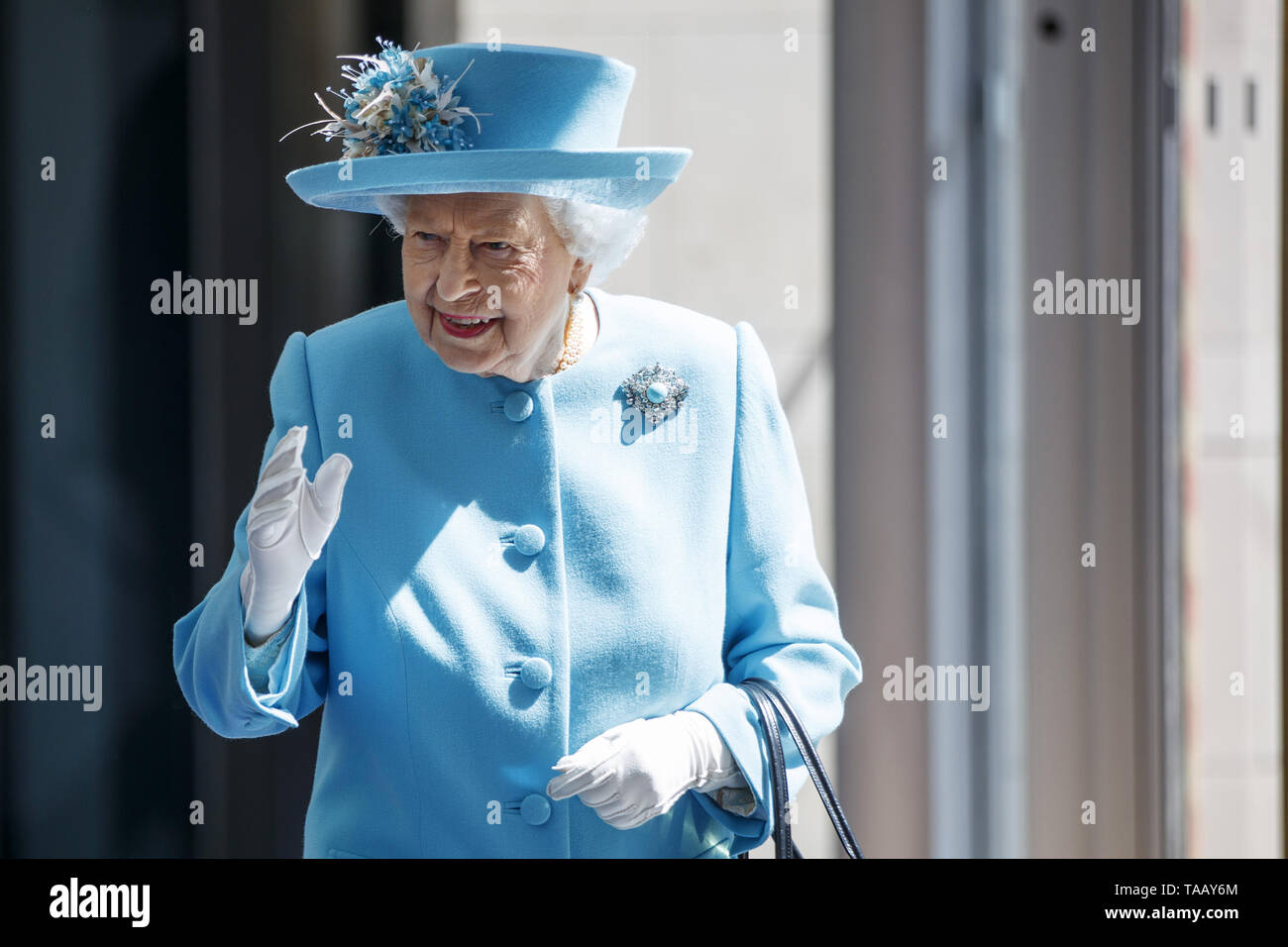 Queen Elizabeth II waves during a visit to the headquarters of British ...