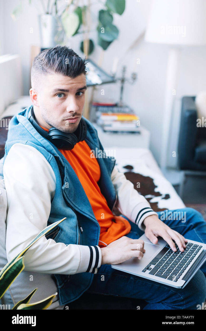 handsome young man using laptop computer with headset Stock Photo - Alamy
