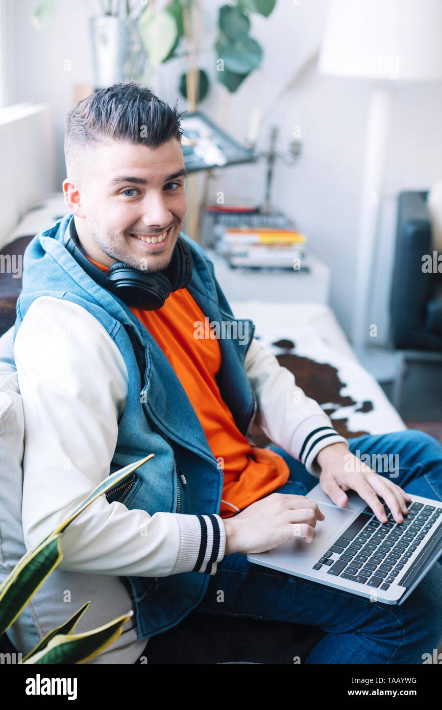 handsome young man using laptop computer with headset Stock Photo - Alamy
