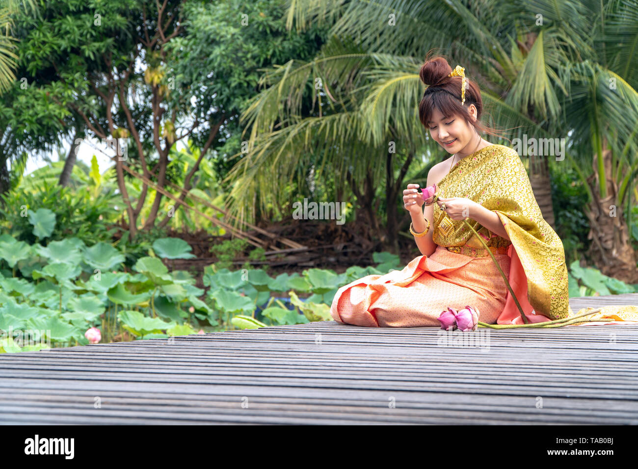 Beautiful asia women wearing traditional Thai dress and sitting on ...