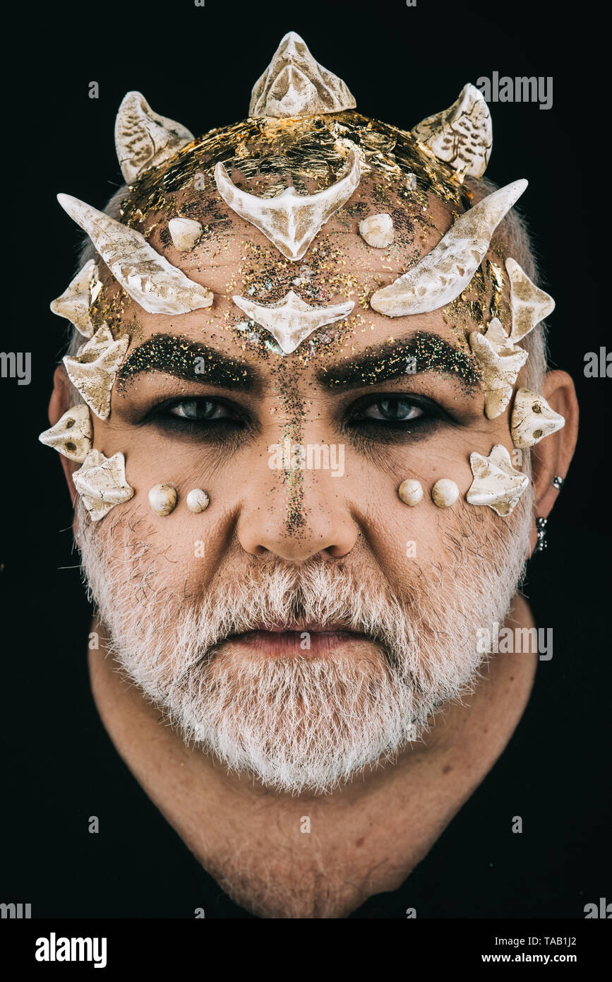 Man with dragon skin and white beard. Monster with sharp thorns and ...