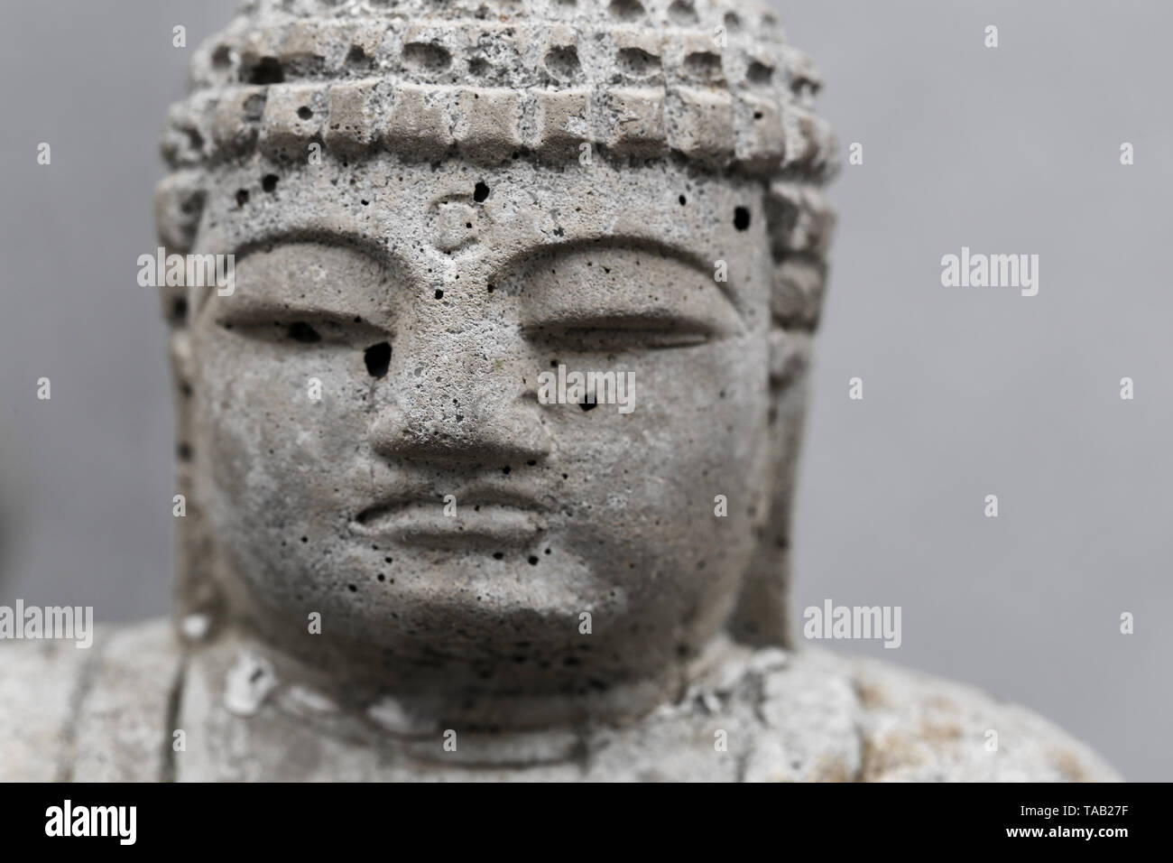 Closeup of a small stone statue of buddha in a hi-res stock photography ...