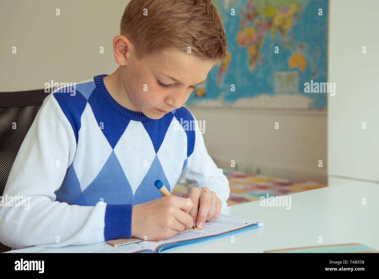Intelligent boy makes homework at desk in his room Stock Photo - Alamy