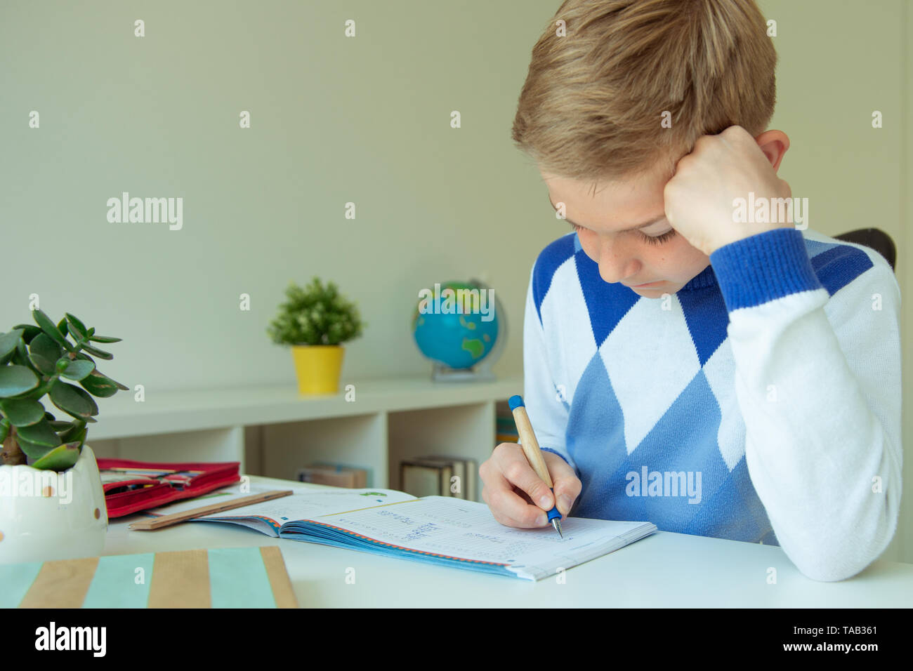 Intelligent boy makes homework at desk in his room Stock Photo - Alamy