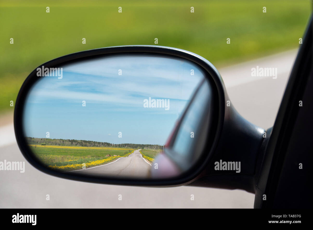 View of the highway in the side mirror of the car. Distance traveled ...