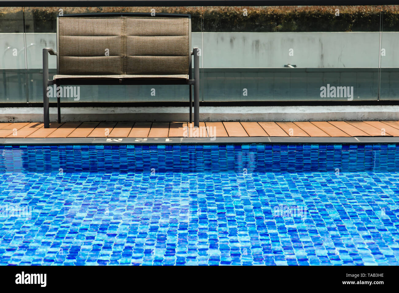 outside swimming pool side with chair Stock Photo - Alamy