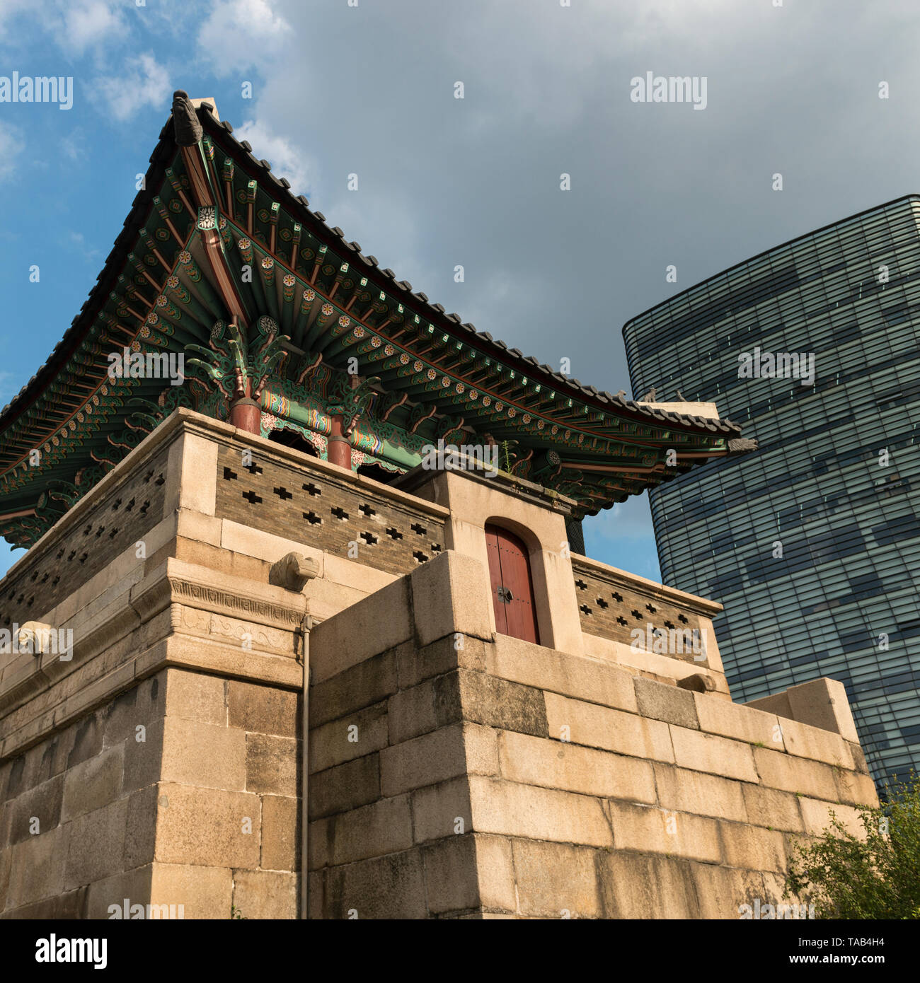Low angle view of traditional watchtower with skyscraper in the ...