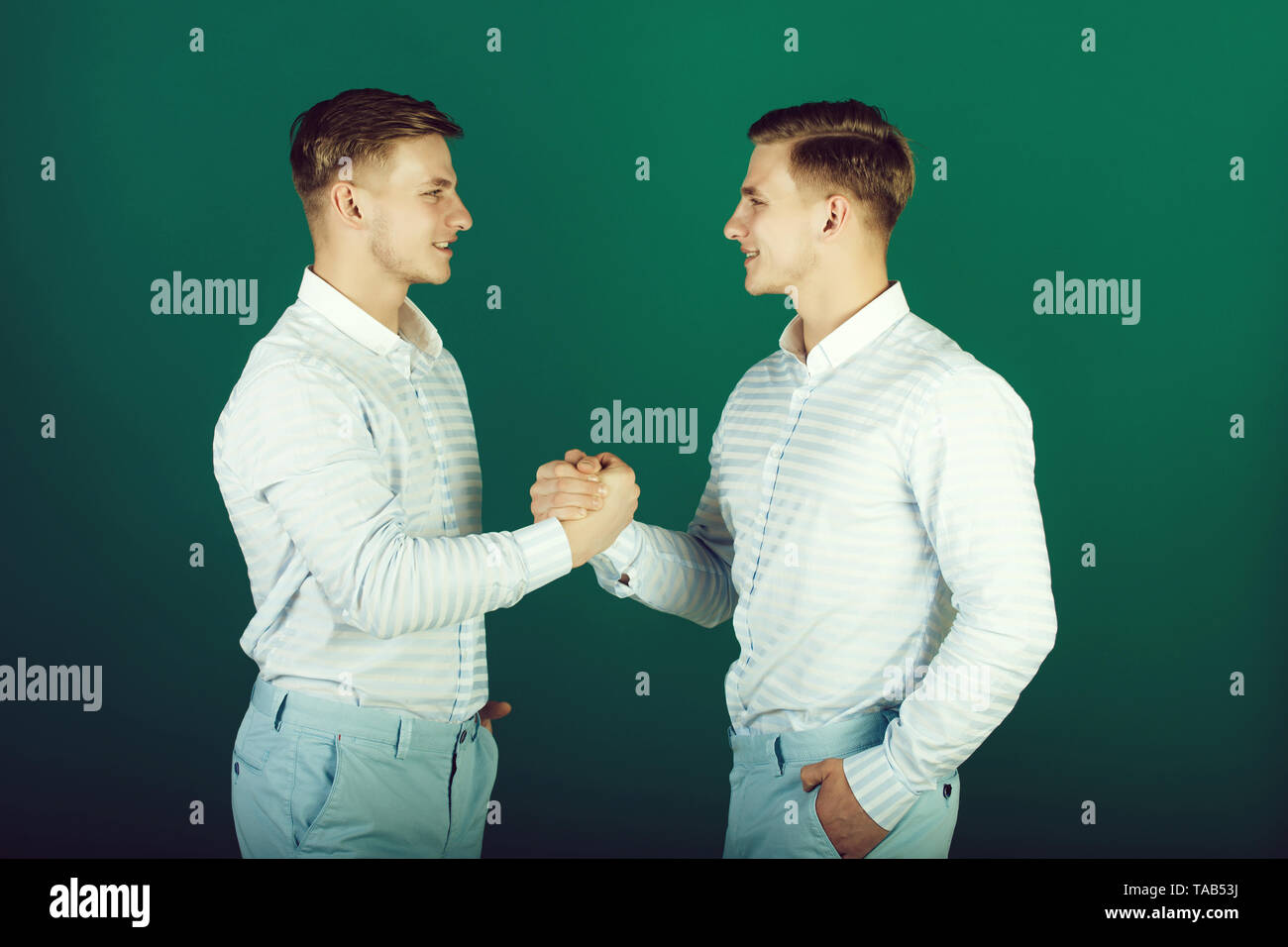Happy men shaking hands Stock Photo - Alamy