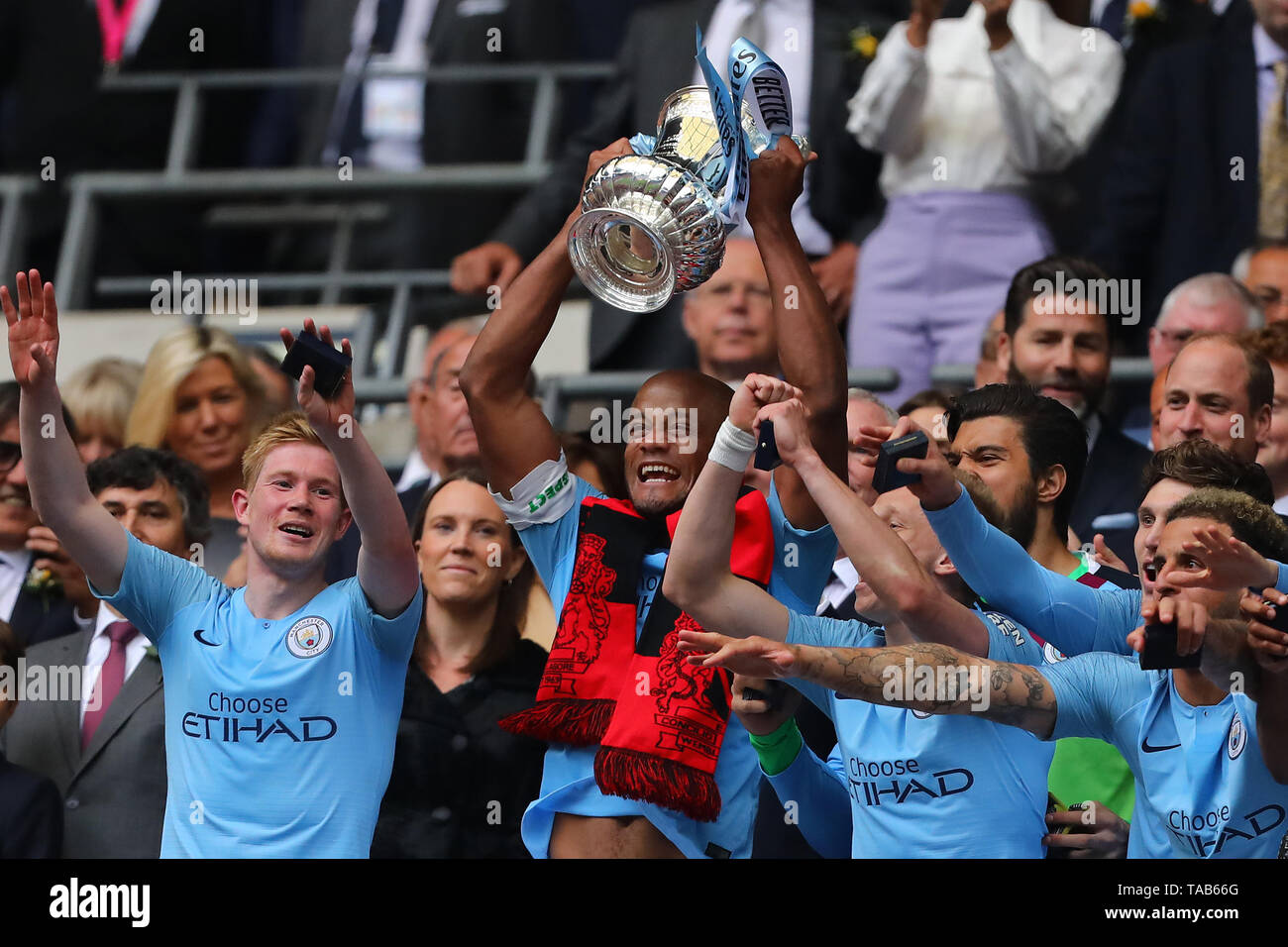 Vincent Kompany of Manchester City lifts the FA Cup trophy after his ...