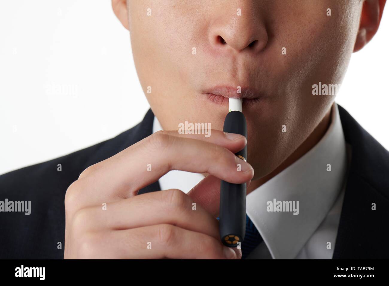 Young Japanese man smoking electronic cigarette Stock Photo - Alamy