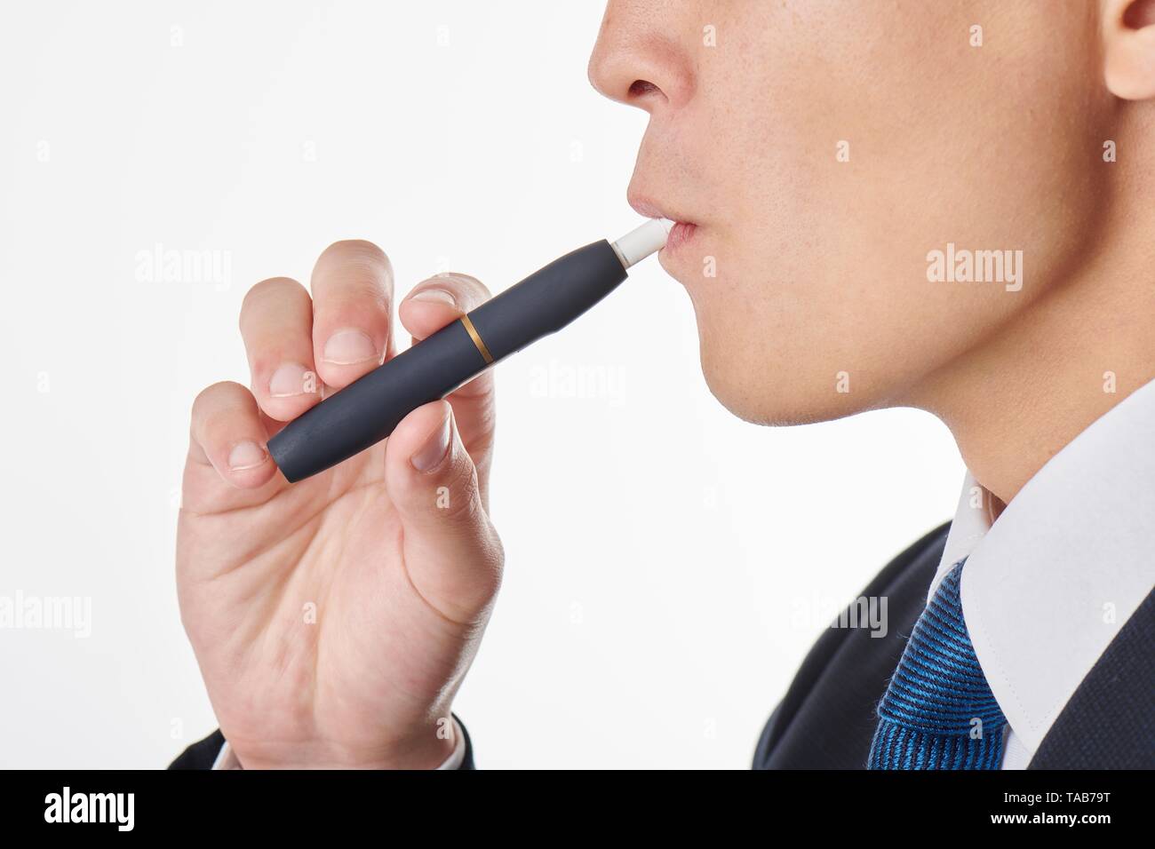 Young Japanese man smoking electronic cigarette Stock Photo - Alamy