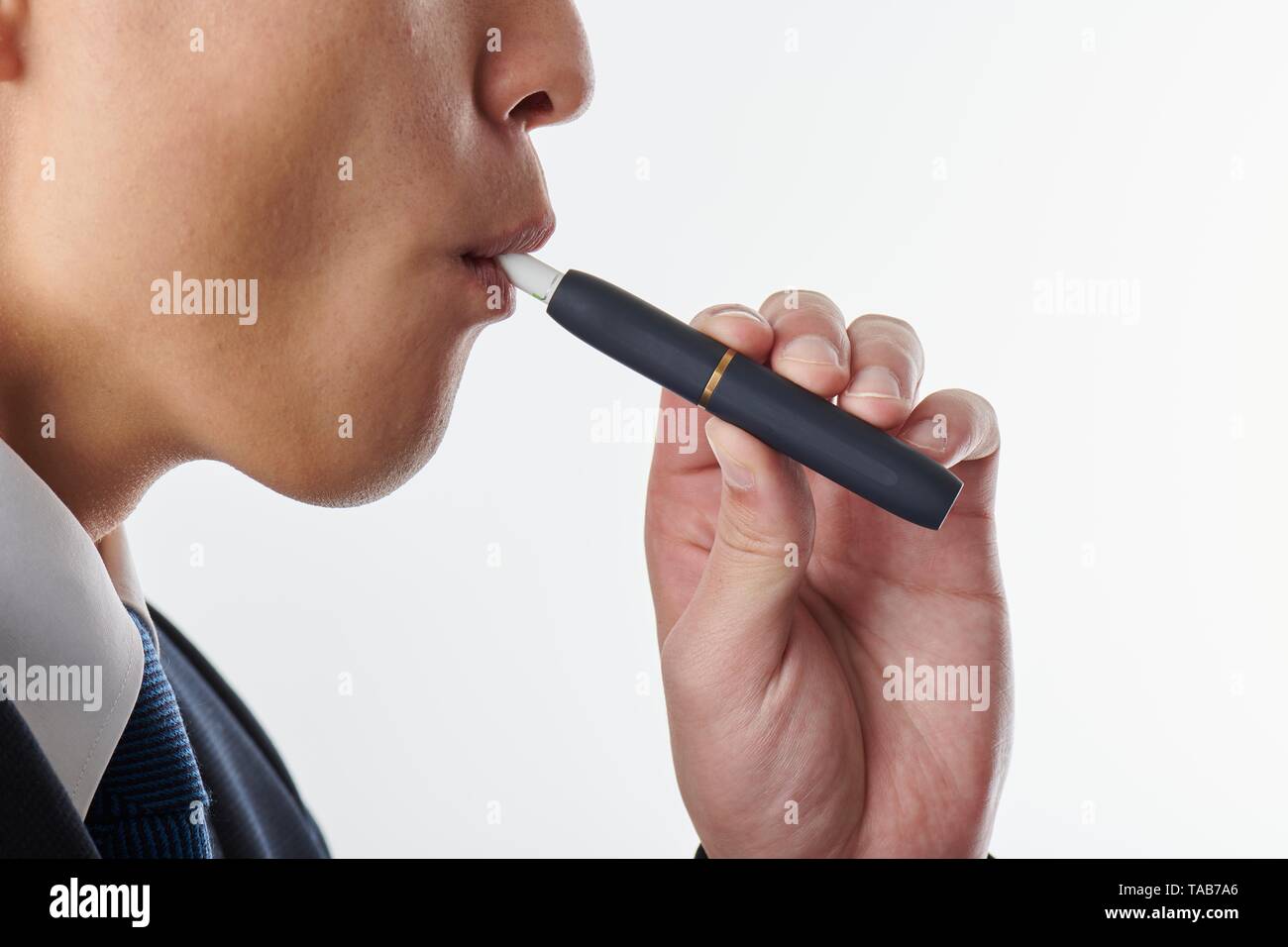 Young Japanese man smoking electronic cigarette Stock Photo - Alamy