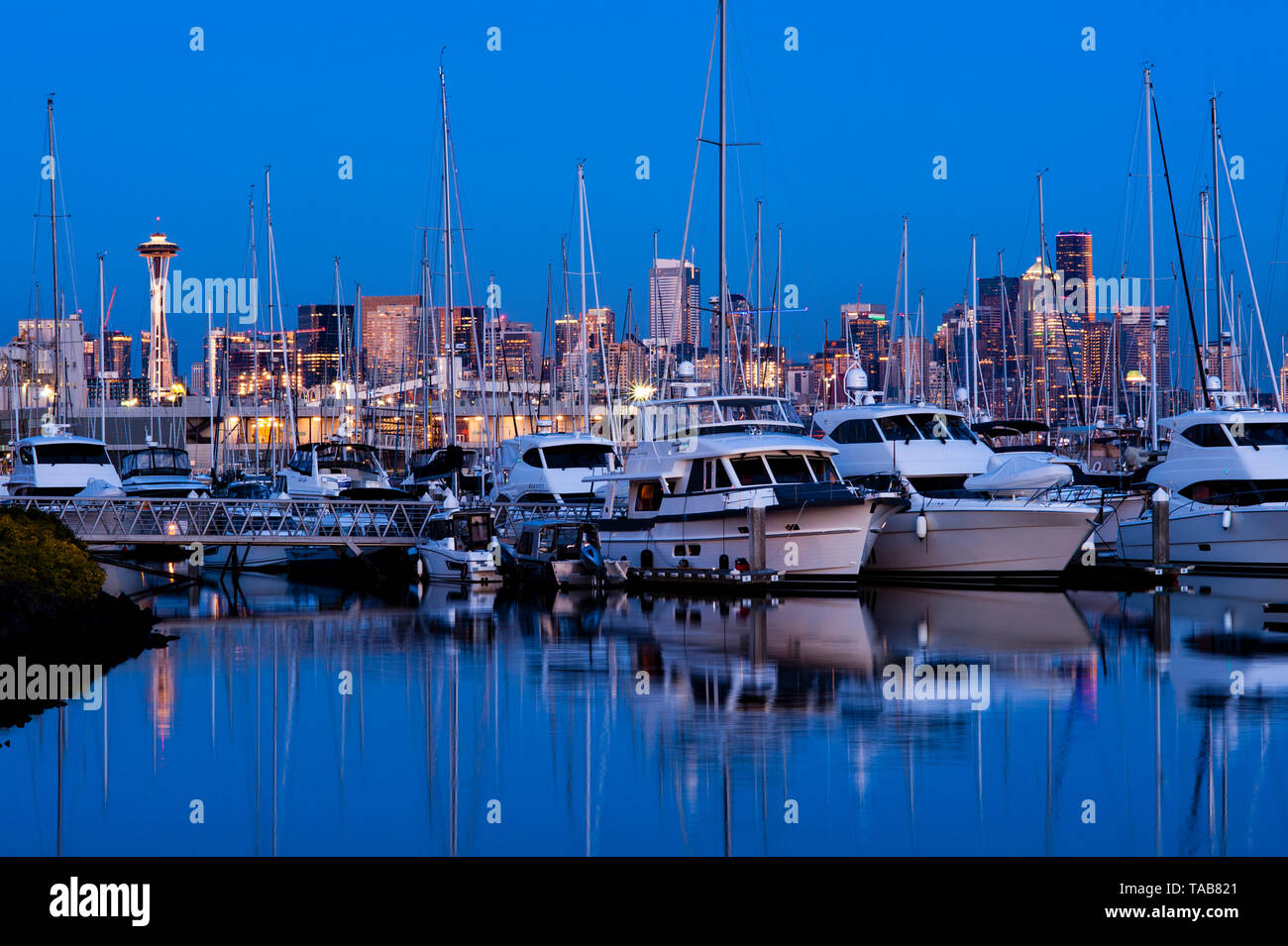 Retro image of Seattle skyline at Elliott Bay marina with boats moored ...