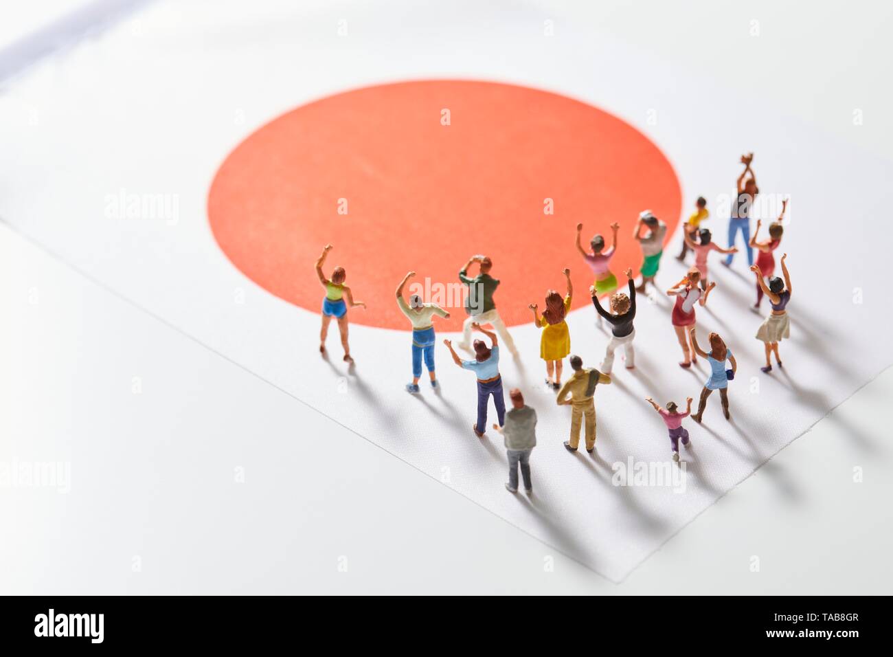 Miniature figures cheering Stock Photo - Alamy