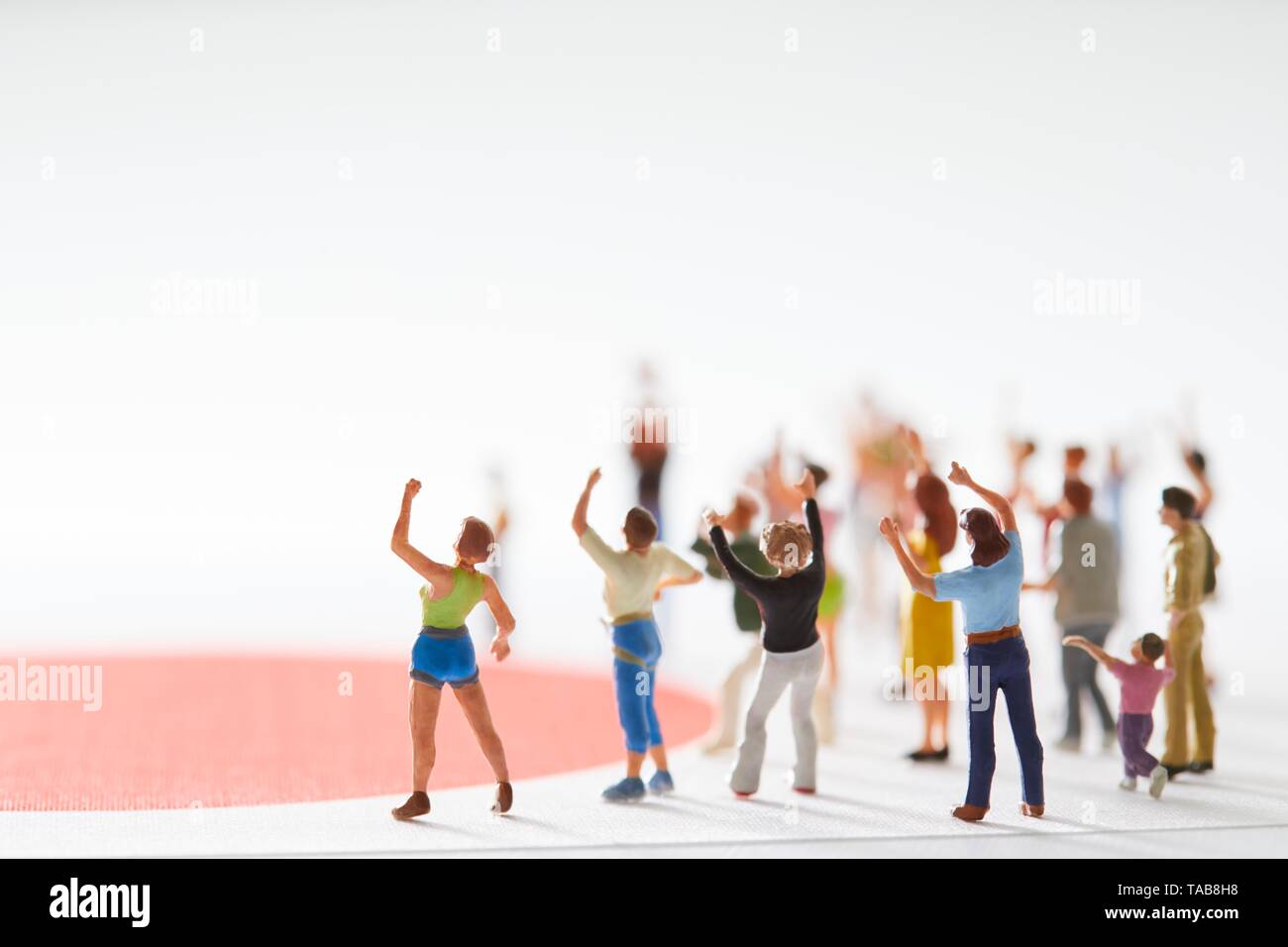 Miniature figures cheering Stock Photo - Alamy