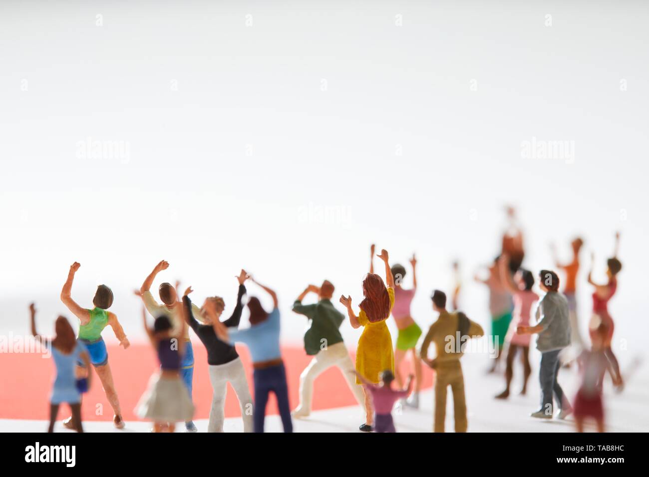 Miniature figures cheering Stock Photo - Alamy