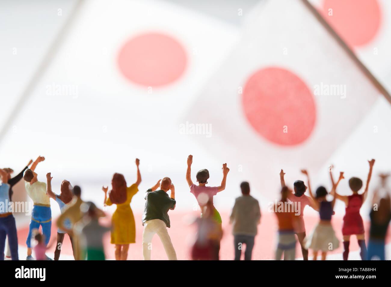 Miniature figures cheering Stock Photo - Alamy