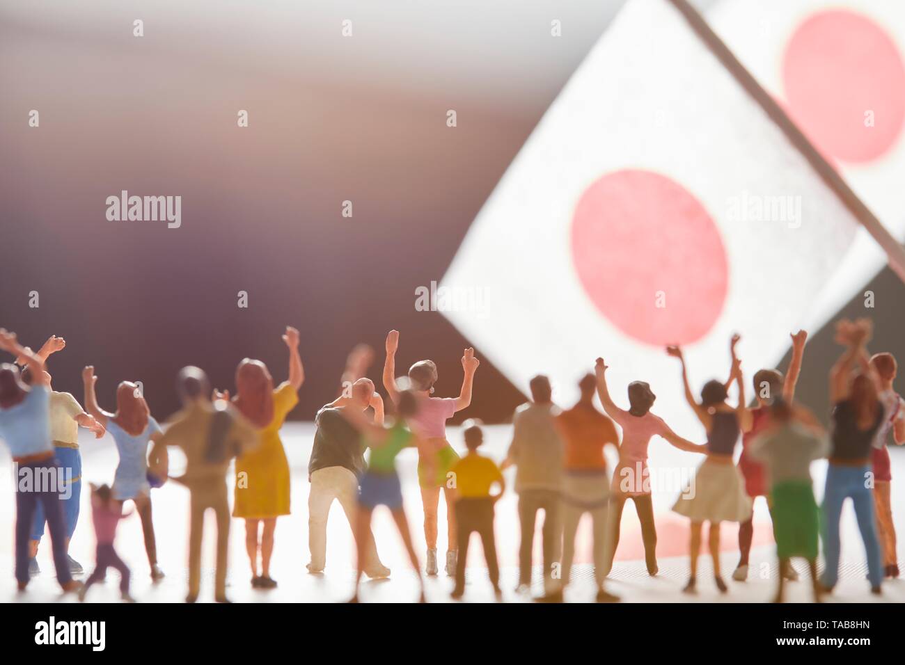 Miniature figures cheering Stock Photo - Alamy
