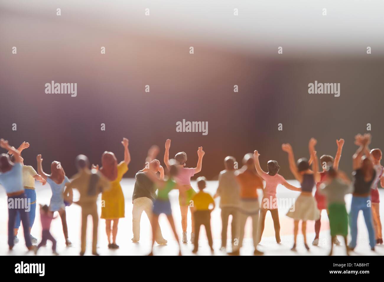 Miniature figures cheering Stock Photo - Alamy