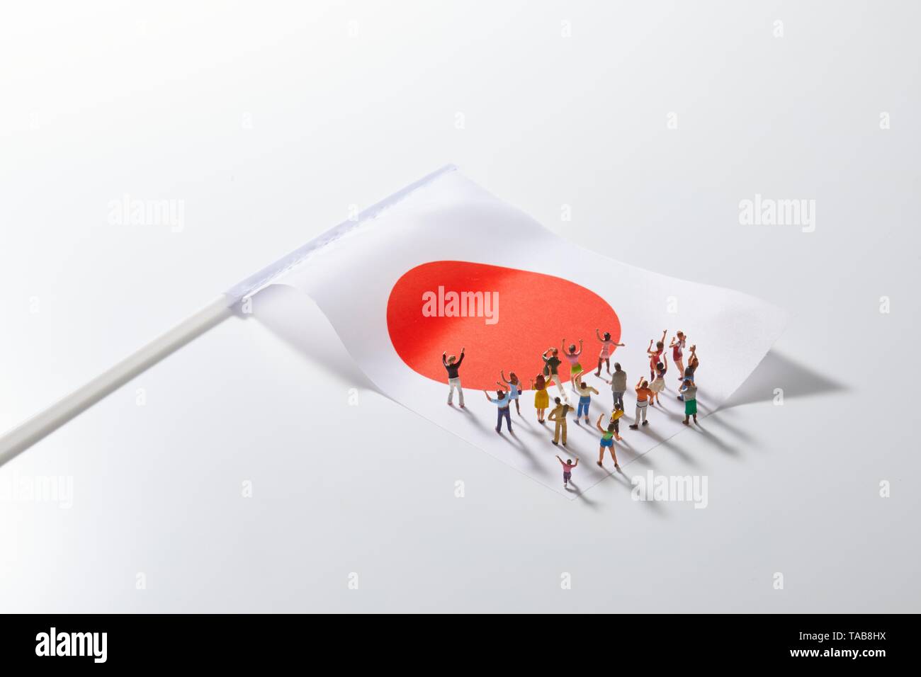 Miniature figures cheering Stock Photo - Alamy
