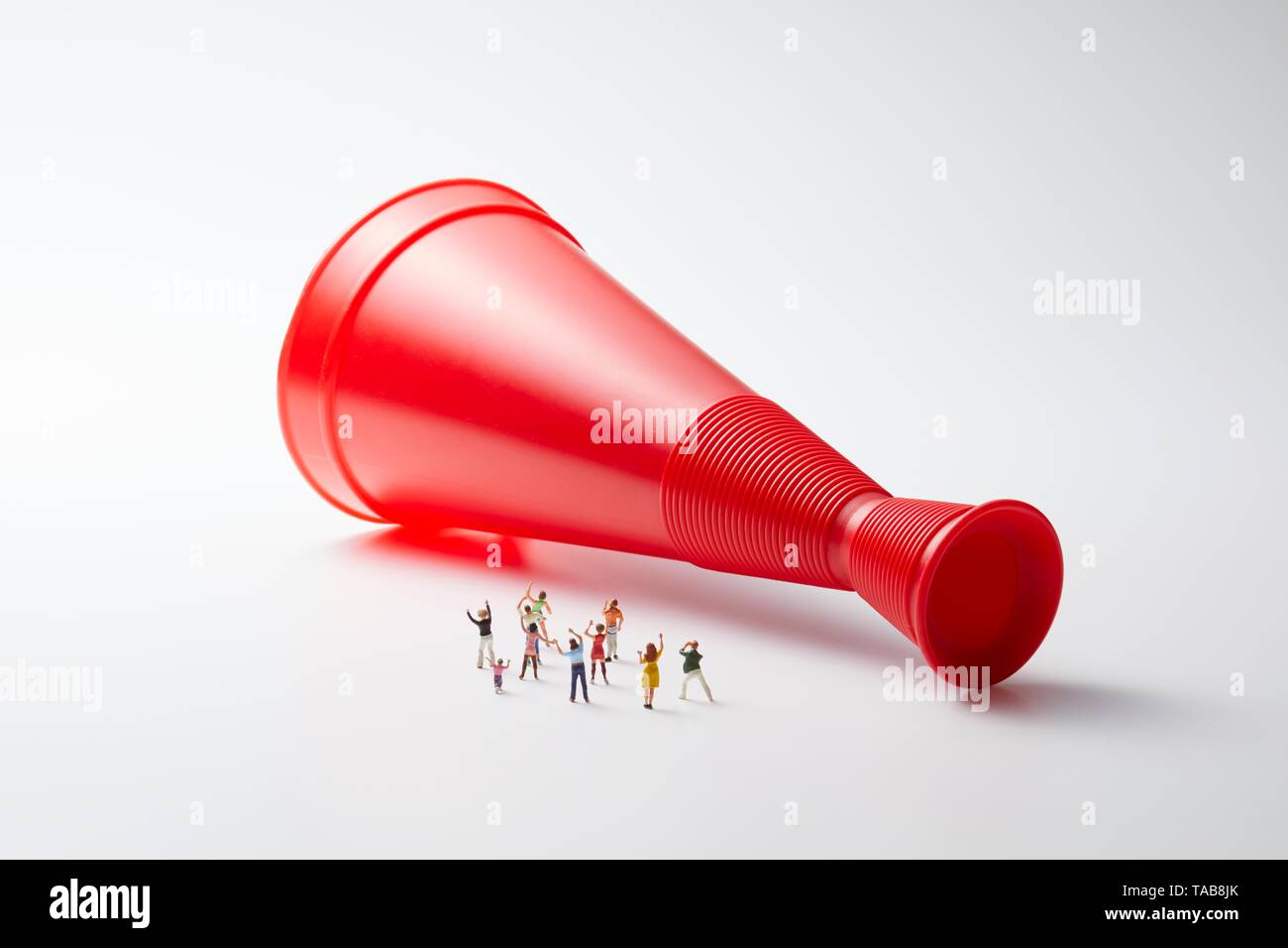 Miniature figures cheering Stock Photo - Alamy