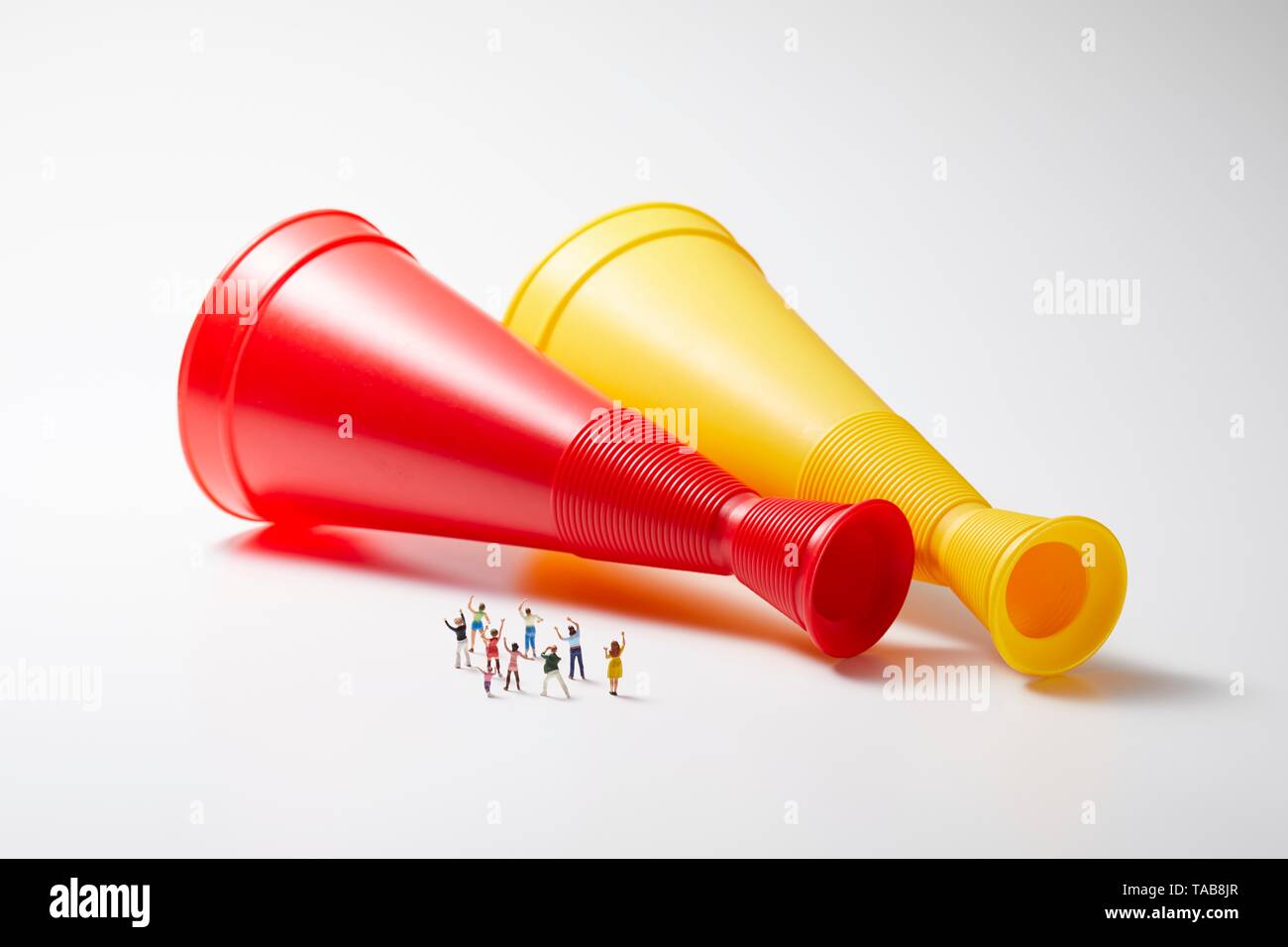 Miniature figures cheering Stock Photo - Alamy