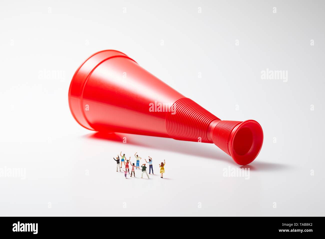 Miniature figures cheering Stock Photo - Alamy