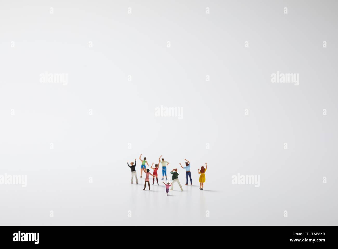 Miniature figures cheering Stock Photo - Alamy