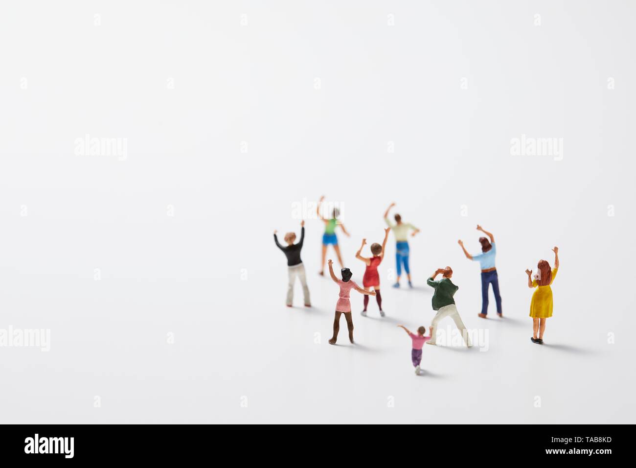 Miniature figures cheering Stock Photo - Alamy
