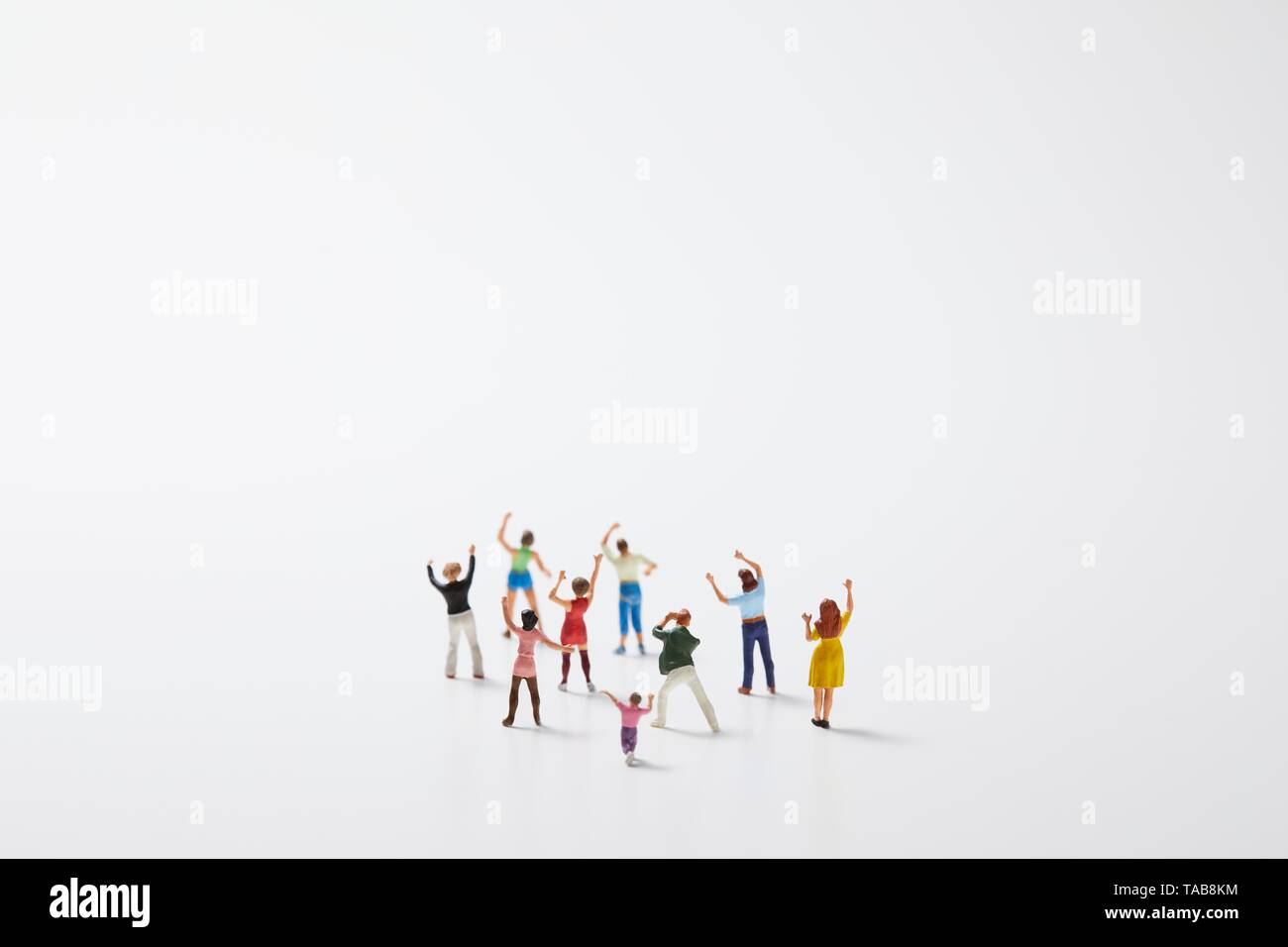 Miniature figures cheering Stock Photo - Alamy