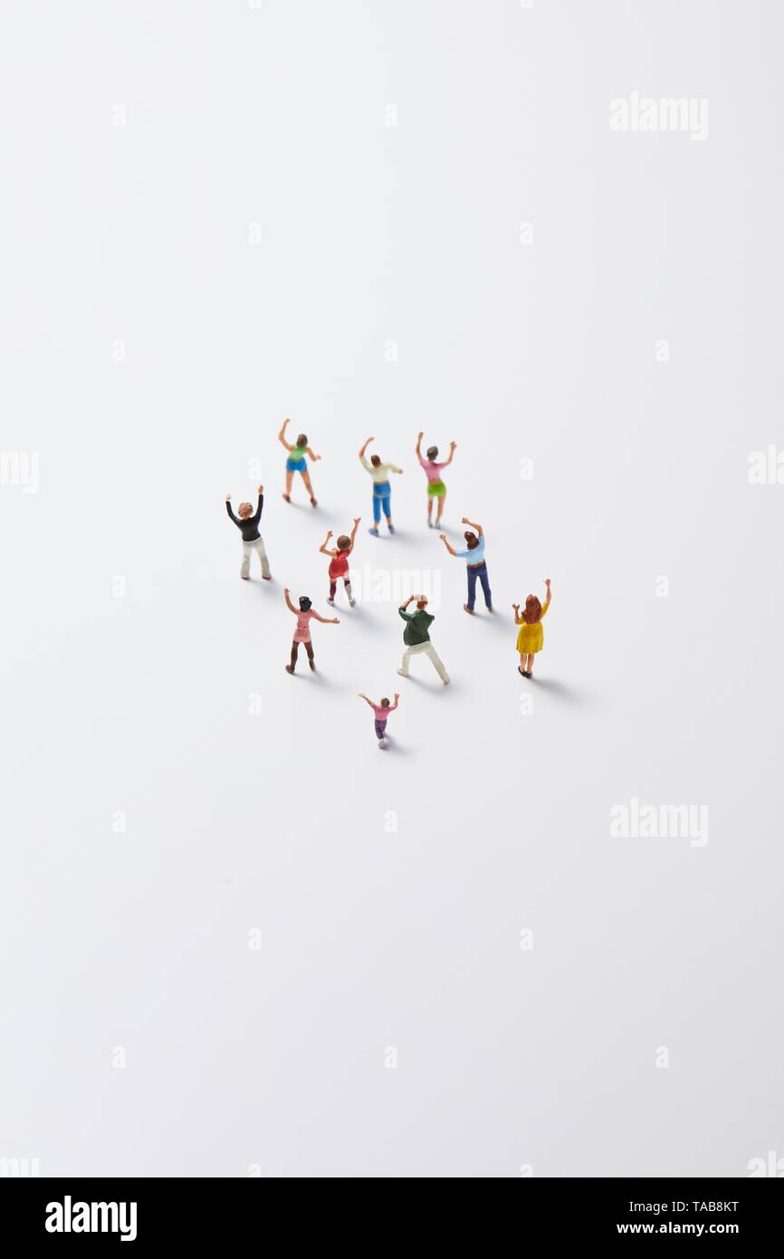 Miniature figures cheering Stock Photo - Alamy