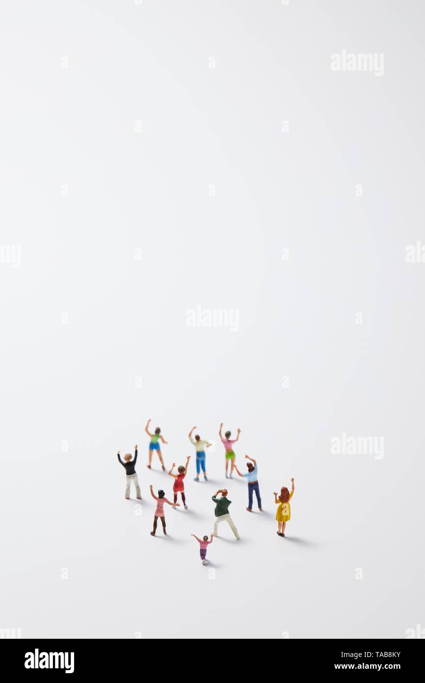 Miniature figures cheering Stock Photo - Alamy