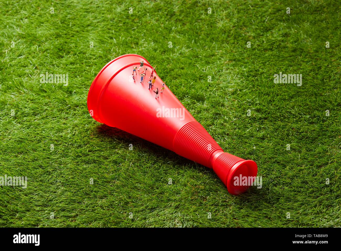 Miniature figures cheering Stock Photo - Alamy