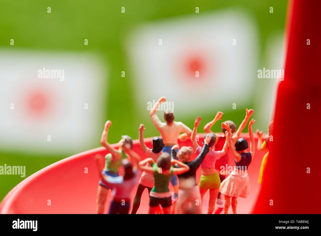 Miniature figures cheering Stock Photo - Alamy
