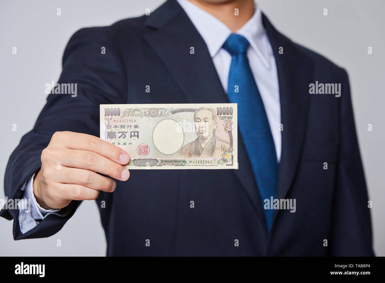 Japanese man holding money bills Stock Photo - Alamy