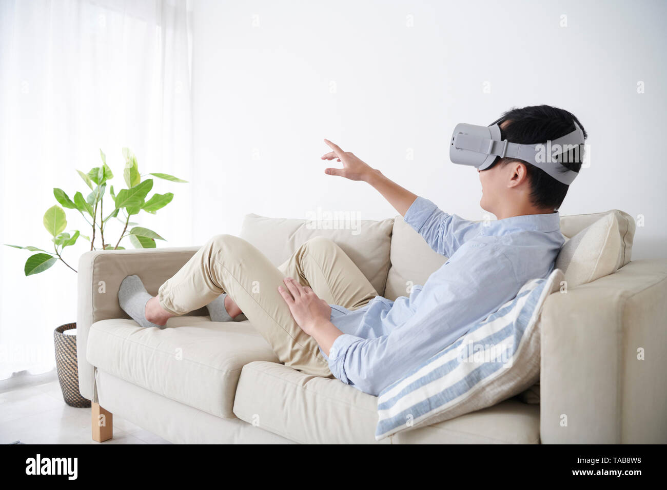 Young Japanese man using VR goggles Stock Photo - Alamy