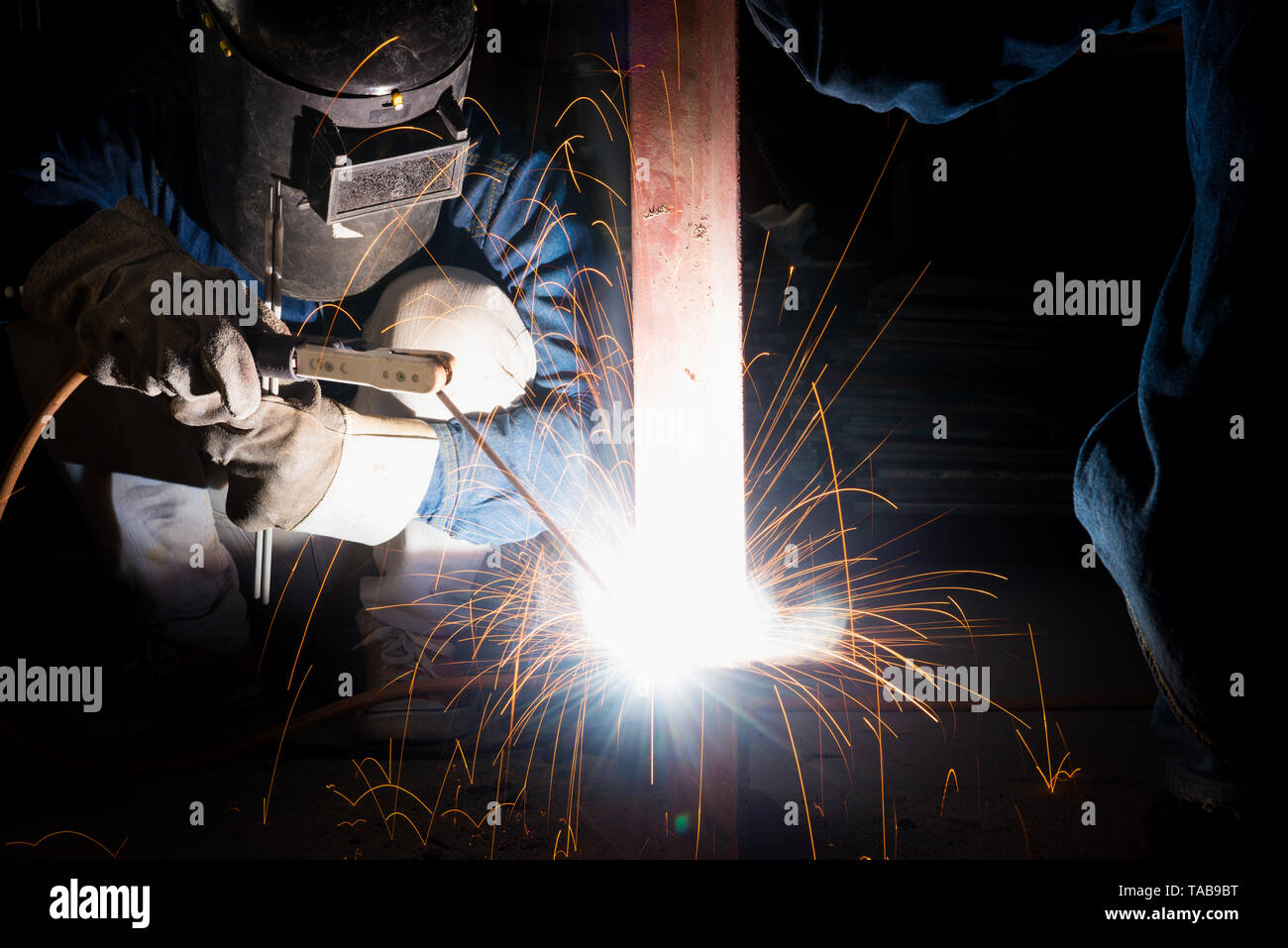 Welding skills training of welder with protective mask and welding ...