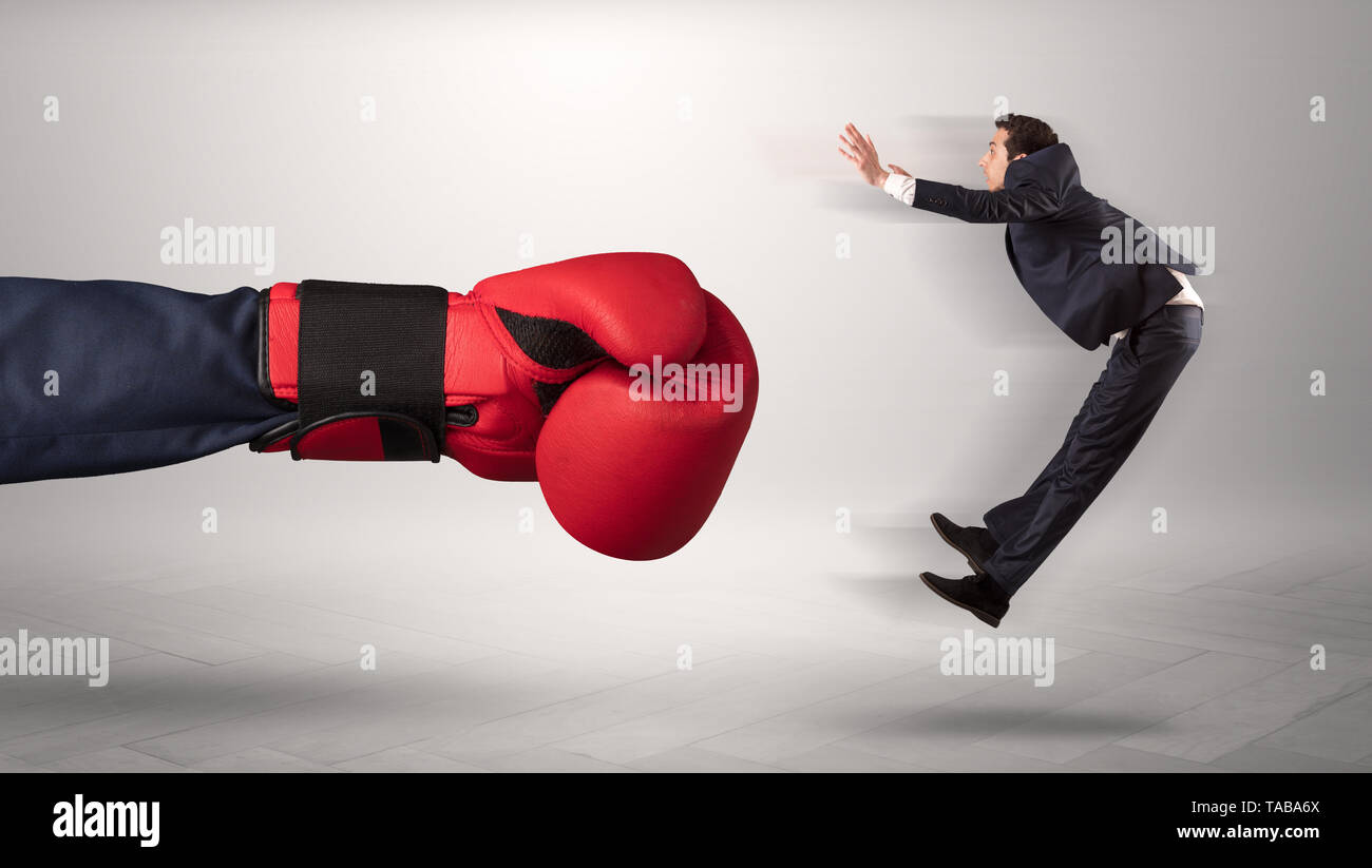 Giant hand gives a kick to a small employee businessman Stock Photo - Alamy