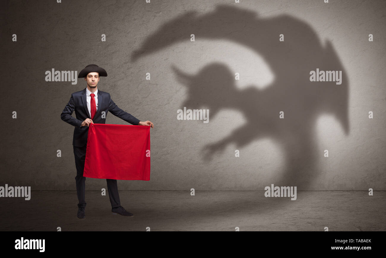 Businessman standing with red cloth in his hand and imp shadow on the ...