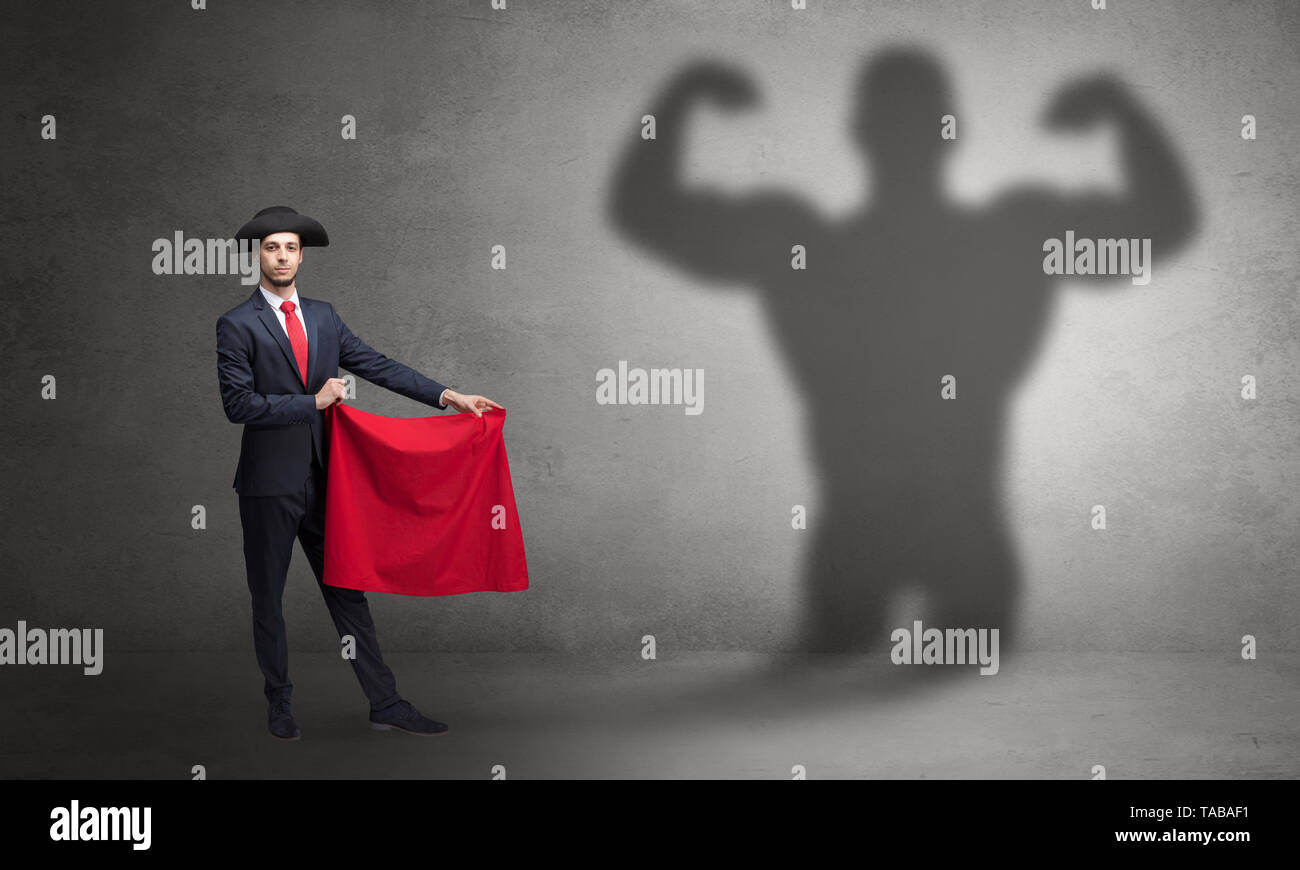 Businessman standing with red cloth on his hand and strong hero shadow ...